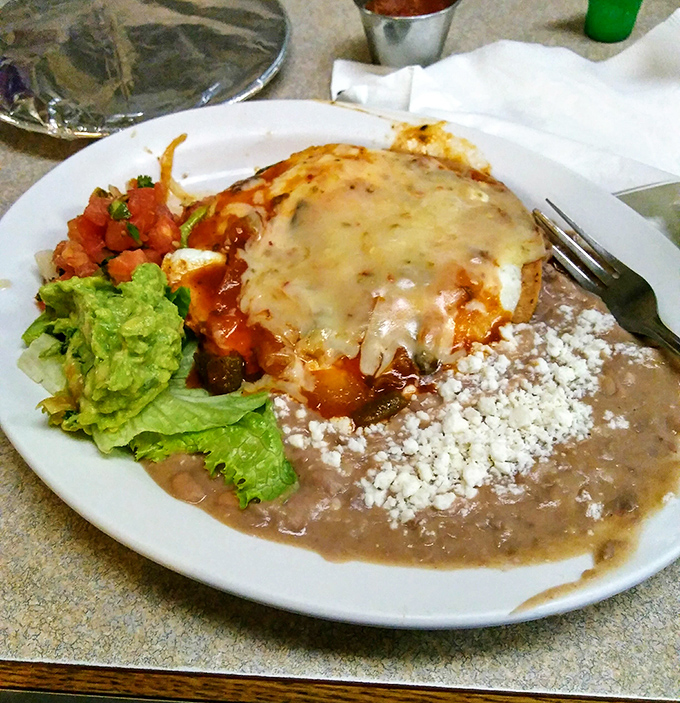 Huevos rancheros that bridge cultures and cure hangovers, topped with melted cheese that stretches like the truth after a fishing trip.