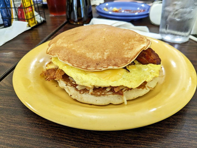 This breakfast sandwich masquerading as a pancake is the morning equivalent of finding an extra $20 in your pocket—unexpected and absolutely delightful.