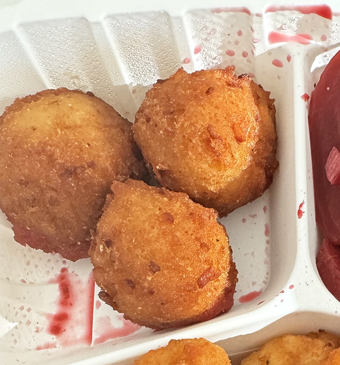 These hush puppies aren't just side dishes—they're little orbs of cornmeal joy that deserve their own fan club.