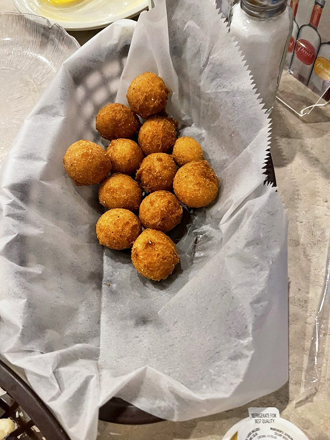 Hush puppies that deserve to speak loudly. These golden orbs of cornmeal perfection are the unsung heroes of the seafood buffet experience.