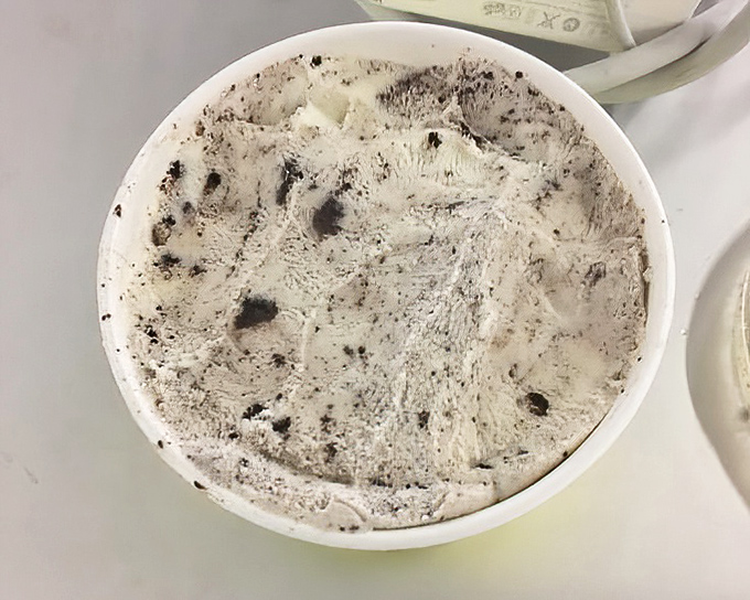 Cookies and cream perfection in that signature yellow cup. The speckled surface promises treasure in every spoonful, like an edible cookies-and-cream galaxy.