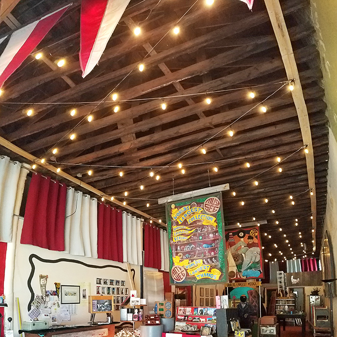 String lights crisscross the rustic ceiling, creating the perfect carnival atmosphere for this celebration of America's obsession with supersized roadside attractions.