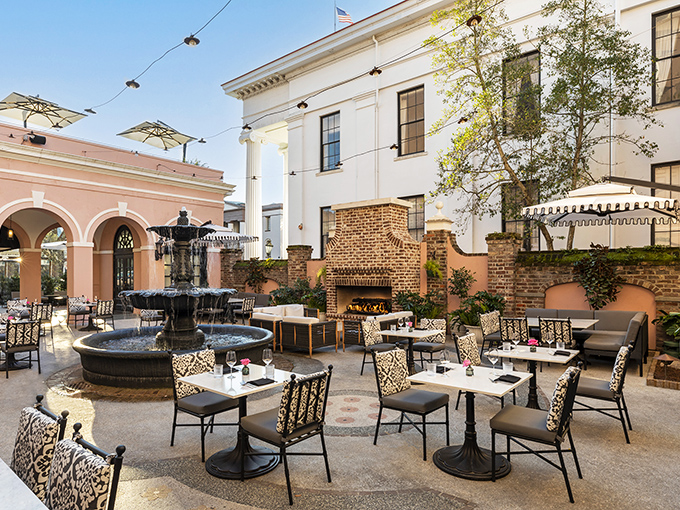 This courtyard dining space epitomizes Charleston's outdoor elegance. Even the fountain seems to whisper, "Your Instagram followers are about to be very jealous."