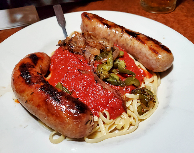 Italian sausages lounging on a bed of pasta like they're on vacation in Sicily &ndash; a beautiful sight that makes your fork hand twitch with anticipation.