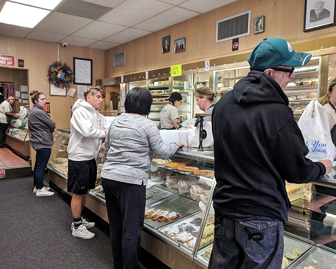The bustling interior reveals the bakery's no-nonsense approach&mdash;that "AUTHORIZED PERSONNEL ONLY" sign is protecting some serious baking magic.