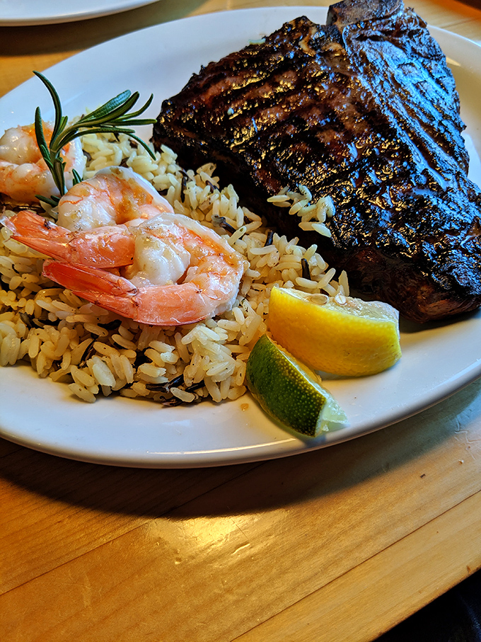 Surf meets turf in perfect harmony&mdash;charred steak with plump shrimp nestled on a bed of rice. The citrus wedges aren't decorative; they're essential.