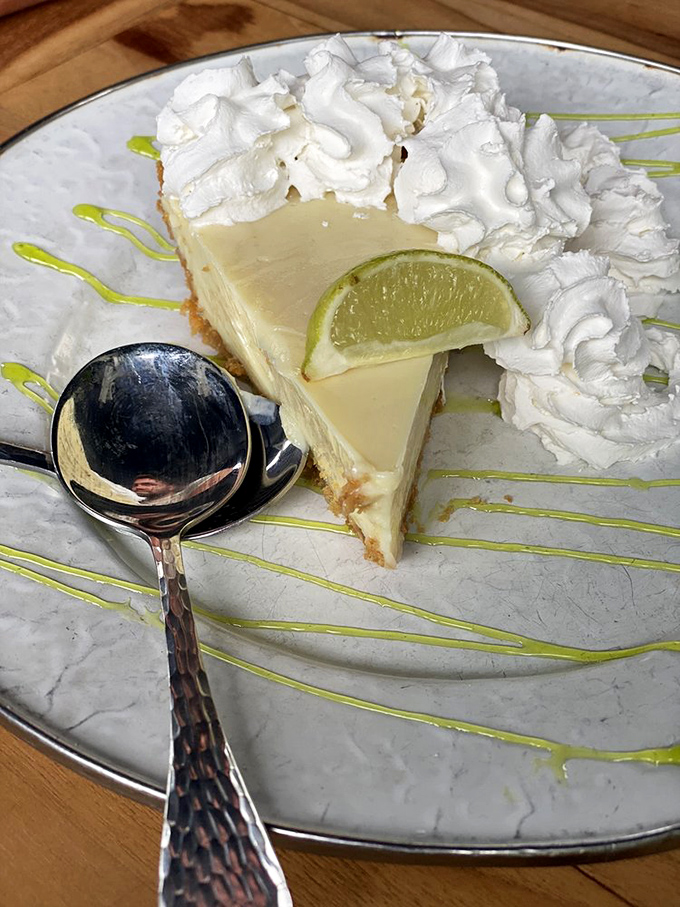 Key lime pie that hits the perfect sweet-tart balance—a slice of Florida sunshine topped with clouds of whipped cream and a lime exclamation point.