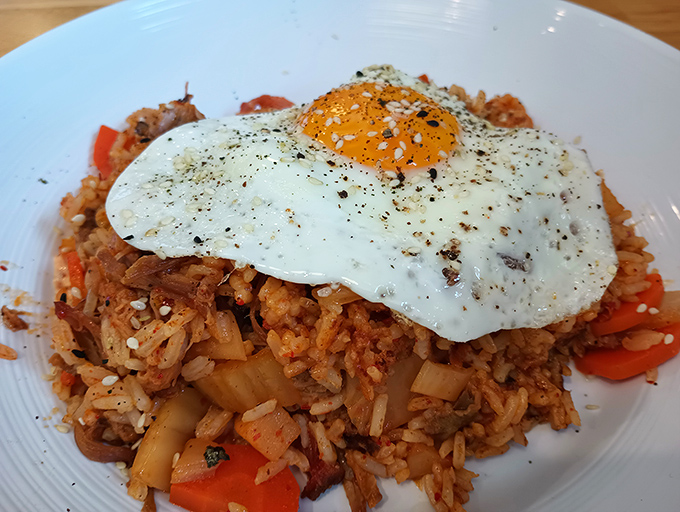 Breakfast of champions. When BBQ meets kimchi fried rice topped with a perfect egg, morning has officially broken good.