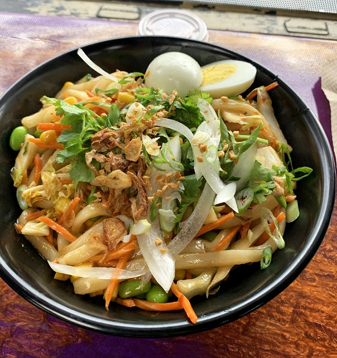 This isn't just stir-fried noodles—it's a colorful battlefield where carrots, onions, and greens unite under the command of perfect seasoning.