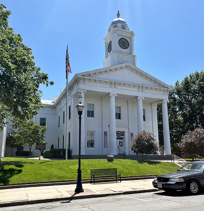 The Lafayette County Courthouse gleams white against a perfect blue sky, its columns and clock tower practically begging for a postcard.