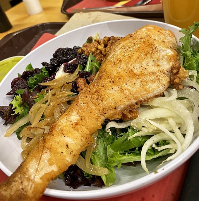 Who knew healthy eating could look this magnificent? This salmon salad proves vegetables can party just as hard as their indulgent menu siblings.