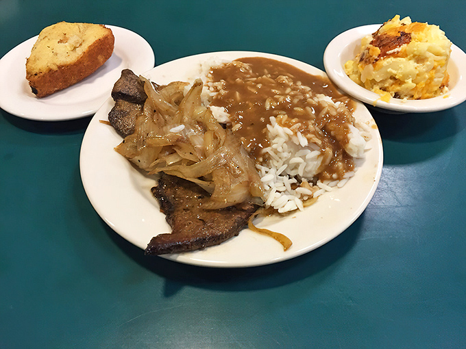 Chopped steak smothered in onions with rice and gravy – the kind of plate that makes you want to hug the cook and cancel your evening plans.