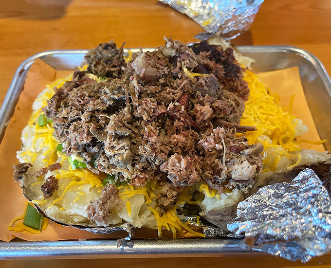 The loaded baker isn't just a potato—it's a canvas where barbecue becomes art, with meat, cheese, and toppings in perfect harmony.