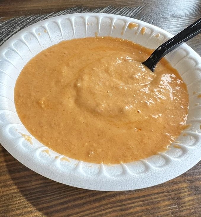 The lobster bisque's rich, velvety texture promises comfort in every spoonful. Like a warm hug from the ocean itself.