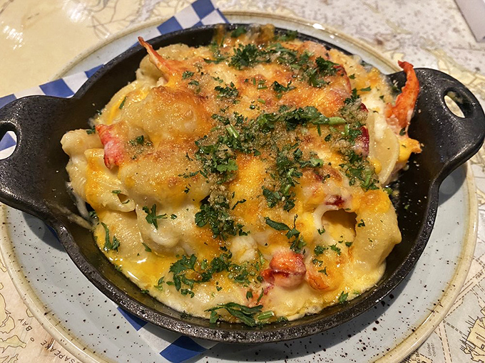 Lobster mac and cheese in a cast iron skillet is proof that some foods are worth loosening your belt for.