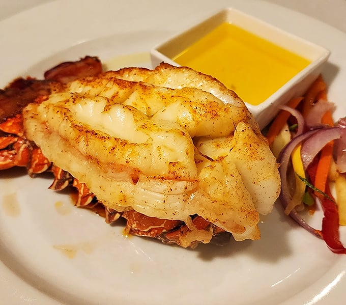 This lobster tail isn't just dinner; it's maritime royalty reclining on its throne of shell with a butter moat.
