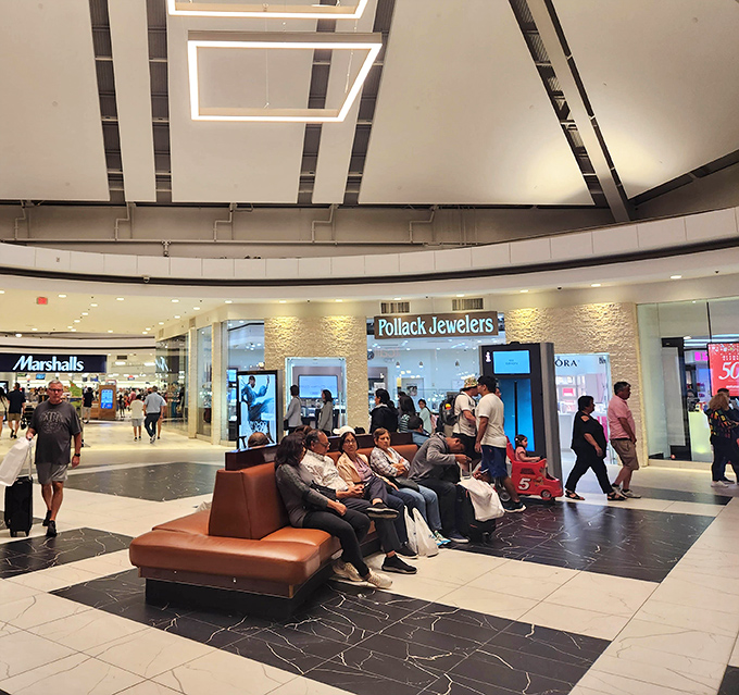 The modern lounge area provides a moment of respite for weary shoppers, strategically placed for that "just one more store" second wind.