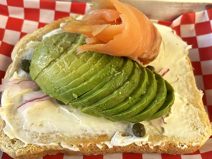 Avocado toast elevated to art form &ndash; creamy green perfection topped with lox that would make any New York deli nod in respectful approval.