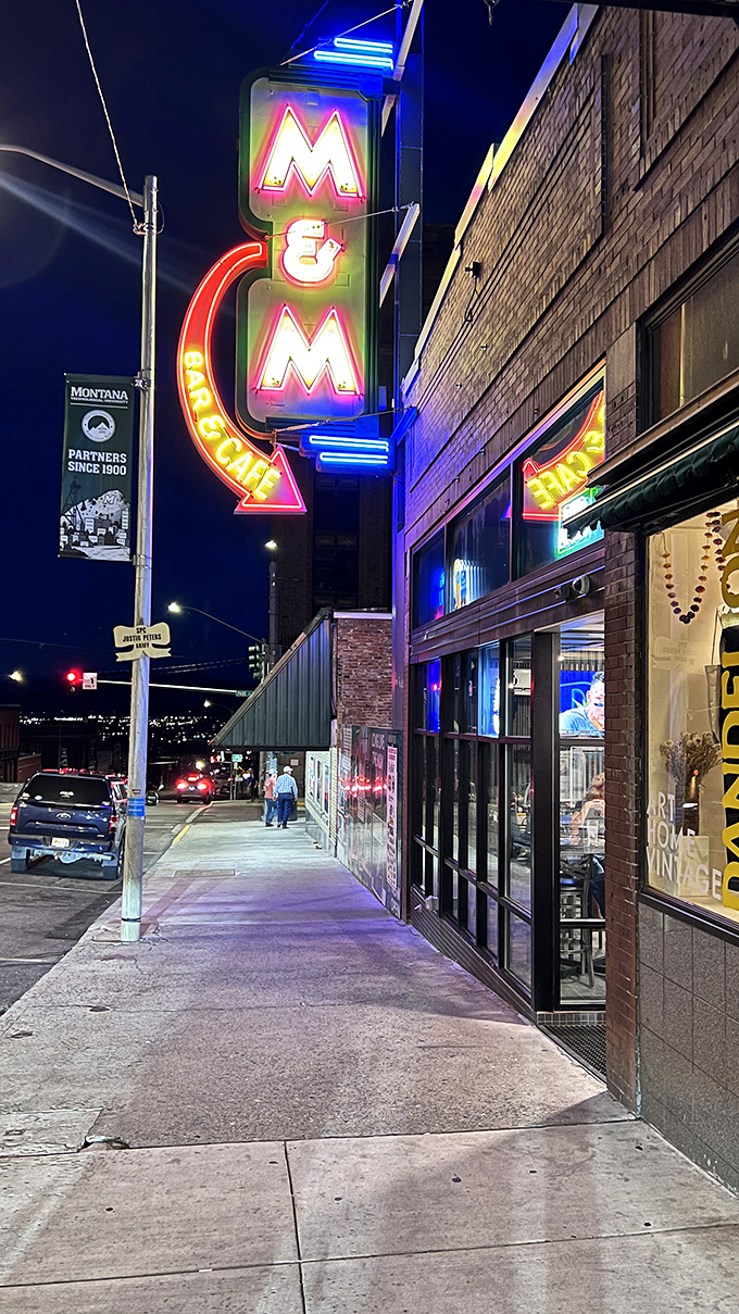 The M&M Bar's neon glow has beckoned Butte residents since 1890, a late-night beacon where mining history meets modern nightlife under Montana's starry canopy.