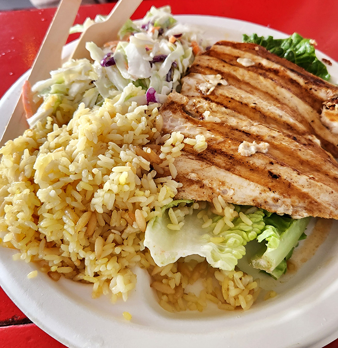 Grilled mahi-mahi that looks like it's auditioning for a food magazine cover, paired with rice that's actually worth eating, not just pushing aside.