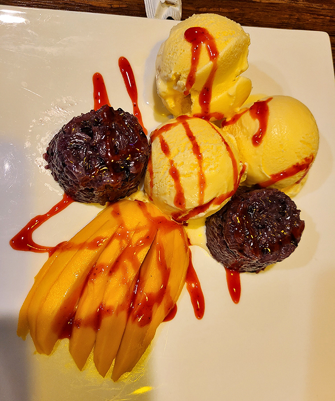 Dessert nirvana: sweet mango slices, sticky rice, and ice cream drizzled with sauce. The holy trinity of Thai sweet endings!