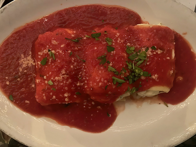 Manicotti dressed in red, like an Italian flag waving deliciously on your plate. The parsley garnish adds that touch of freshness.
