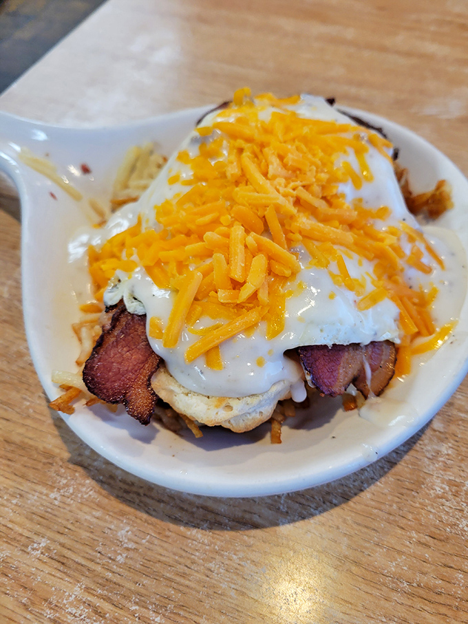 This isn't just breakfast – it's breakfast architecture. Layers of eggs, cheese, bacon and biscuit creating a savory skyscraper of morning delight.