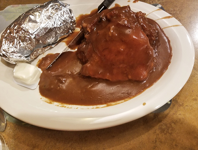 Meatloaf that doesn't apologize for being comfort food. Draped in rich gravy, it's what hugs would taste like if they were edible.