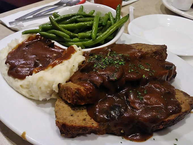 Meatloaf dinner that transports you straight to Sunday suppers at grandma's house, complete with gravy that should be bottled and sold as liquid happiness.