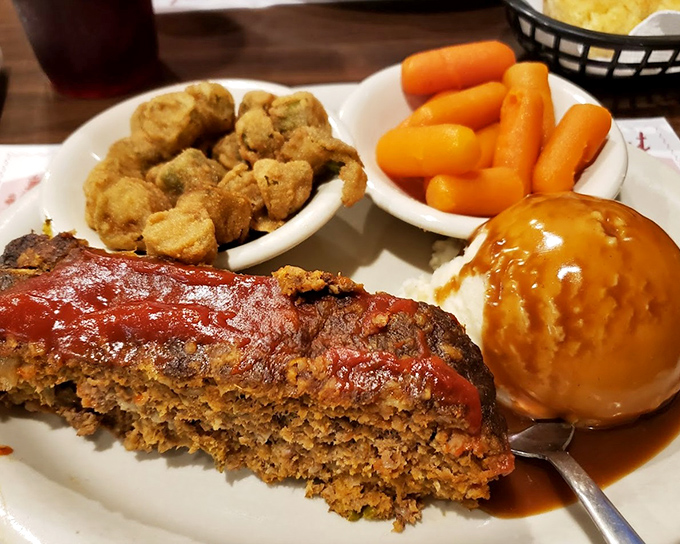Meatloaf that would make your grandmother both jealous and proud, topped with that glossy tomato glaze that signals comfort in any language. 