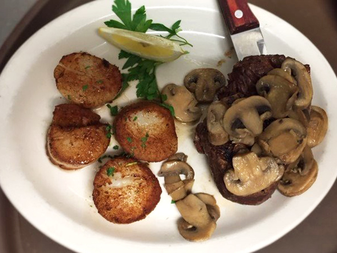 Filet mignon with saut&eacute;ed mushrooms and scallops&mdash;a surf and turf liaison that would make Neptune and the cattle gods equally proud.