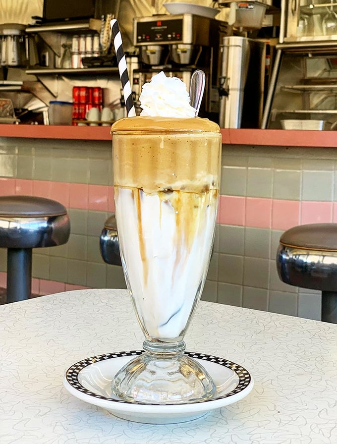 This isn't just a milkshake &ndash; it's a frothy tower of nostalgia served in a glass tall enough to house your childhood dreams.