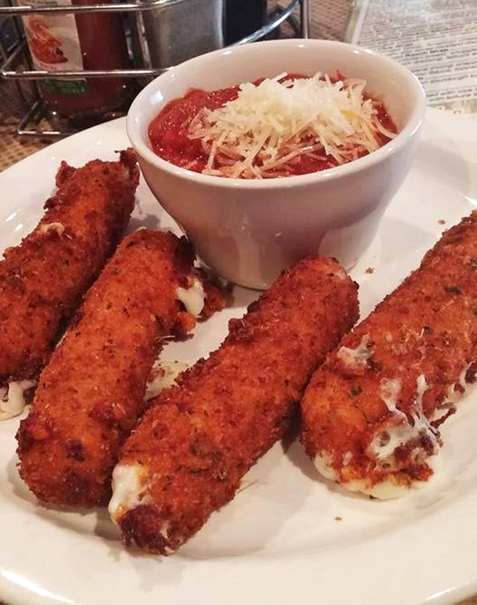 These aren't just mozzarella sticks; they're crispy vessels of molten cheese joy served with marinara that's practically asking for a spoon.