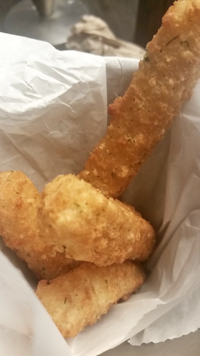 These aren't your average mozzarella sticks; they're crispy-coated flavor torpedoes that stretch dramatically with each delightful pull.