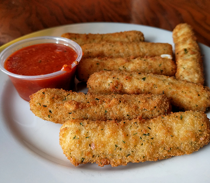 Golden, crispy mozzarella sticks: the universal language of comfort. That marinara looks ready for its dipping destiny.