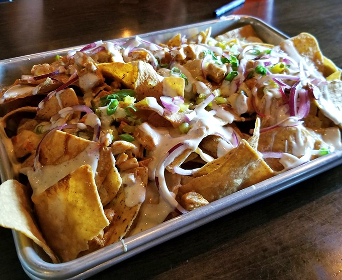 Loaded nachos that defy gravity and good sense &ndash; a mountain of chips, cheese, and toppings that makes sharing both necessary and slightly contentious.