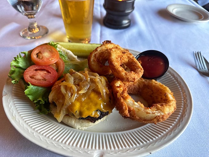 The Napoleon Bacon Burger arrives with an entourage of golden fries and a pickle spear standing at attention. This isn't fast food; it's food worth slowing down for.
