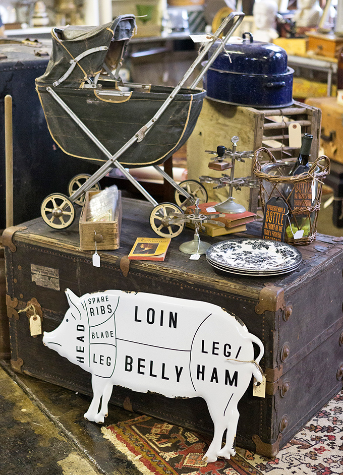 That vintage baby carriage atop an antique trunk creates the perfect still life of American childhood through the decades.