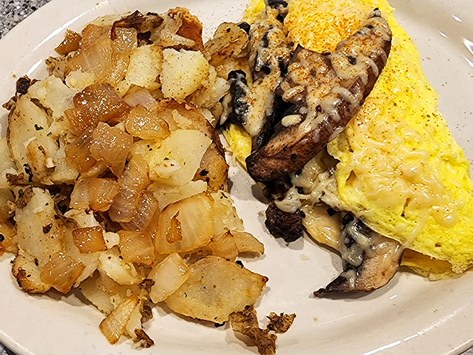 This mushroom and cheese omelet performs the perfect breakfast balancing act&mdash;fluffy eggs, savory fillings, and those home fries that deserve their own fan club.
