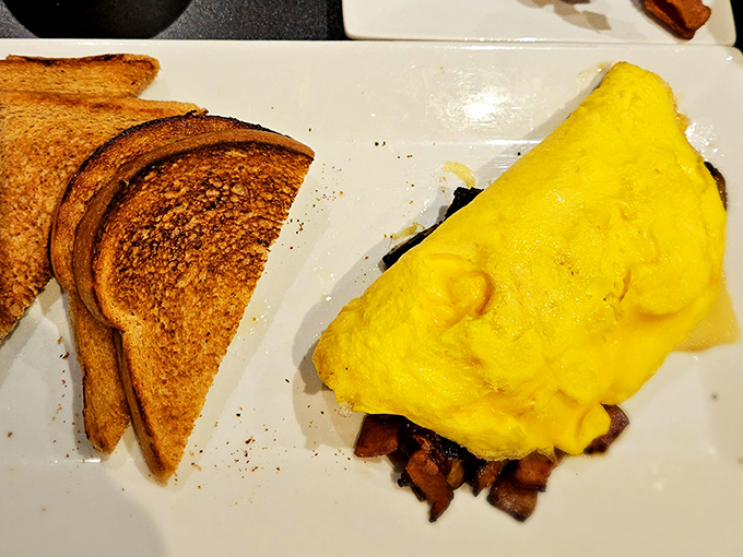 An omelet so perfectly executed it belongs in the breakfast hall of fame. That golden exterior hides treasures within.
