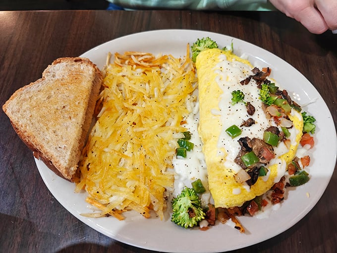 When your omelet is stuffed this full and your hashbrowns are this crispy, you've officially won the morning meal lottery.