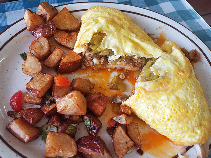 An omelet so perfectly executed it deserves its own gold medal, with home fries that could make a potato farmer proud.