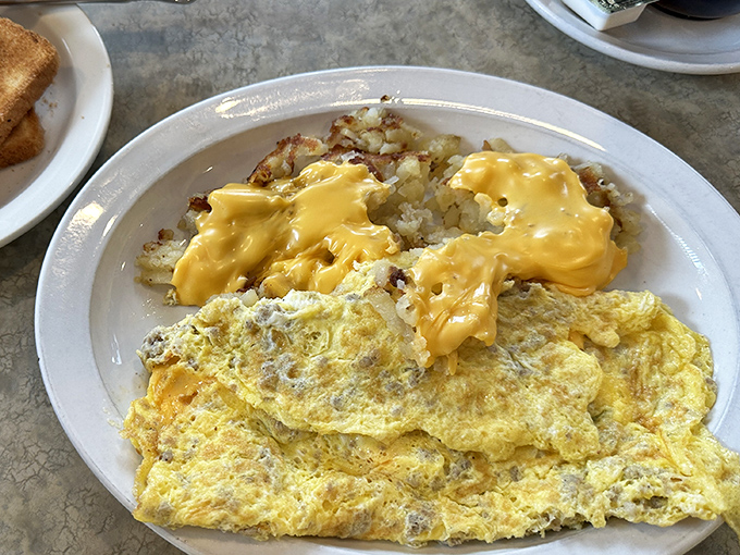 This omelet and cheese-draped hash browns combo is the breakfast equivalent of a warm hug from your favorite aunt&mdash;familiar, comforting, and exactly what you need.