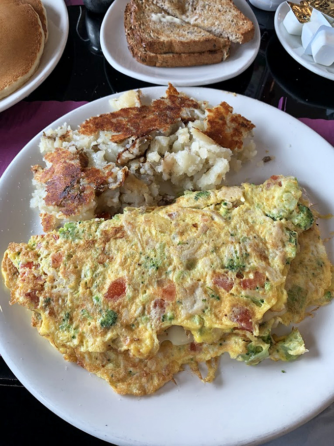 When an omelet is executed this perfectly, with vegetables folded into fluffy eggs alongside golden-brown potatoes, Monday mornings suddenly become bearable.
