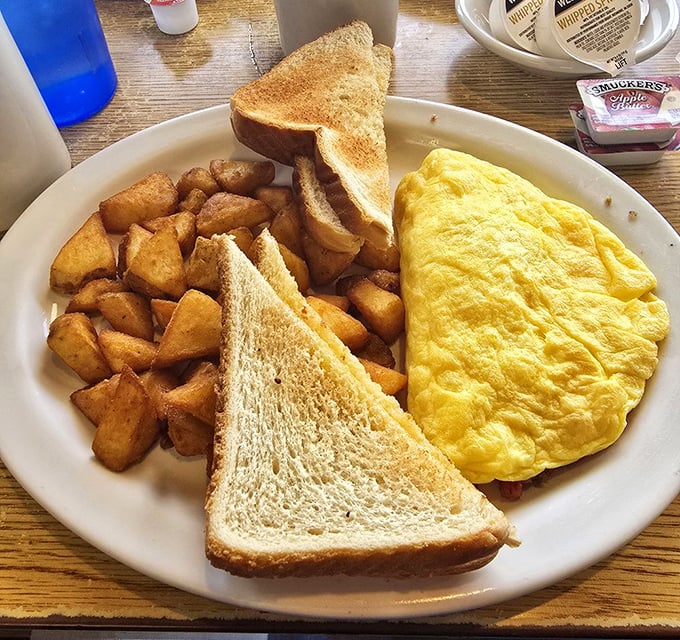 The holy trinity of breakfast: a perfectly folded omelet, crispy home fries, and toast standing by for yolk-sopping duty. Morning bliss achieved.