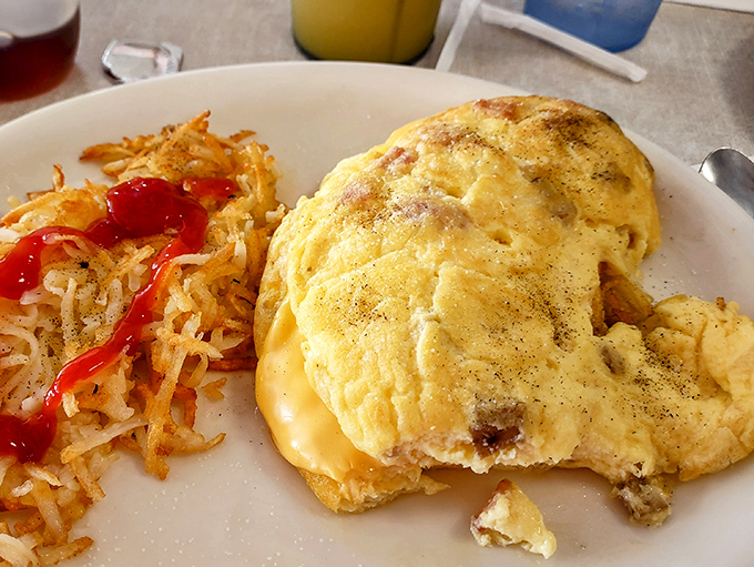 An omelet that's achieved the perfect balance between fluffy and substantial, with hash browns that have achieved crispy-exterior perfection.