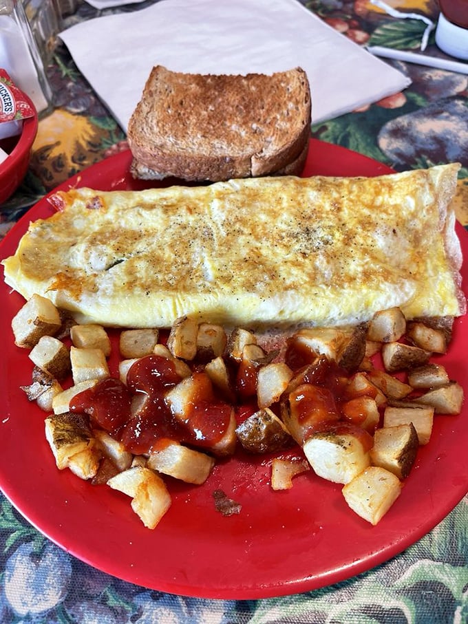 This omelet arrives wearing its golden-brown coat like a breakfast superhero, ready to save your hungry morning.