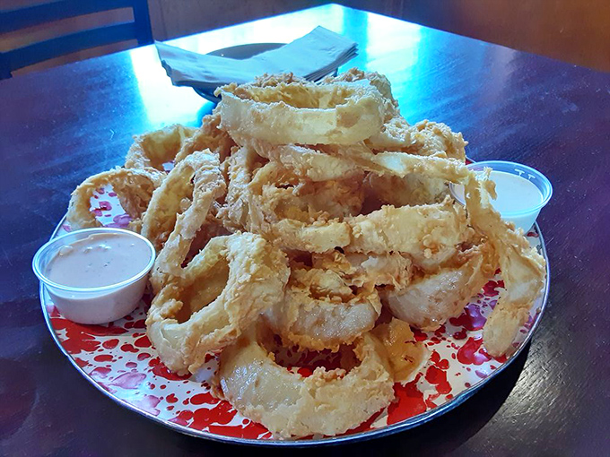Onion rings stacked like edible Olympic rings&mdash;crispy, golden halos that make you wonder why anyone bothers with regular onions.
