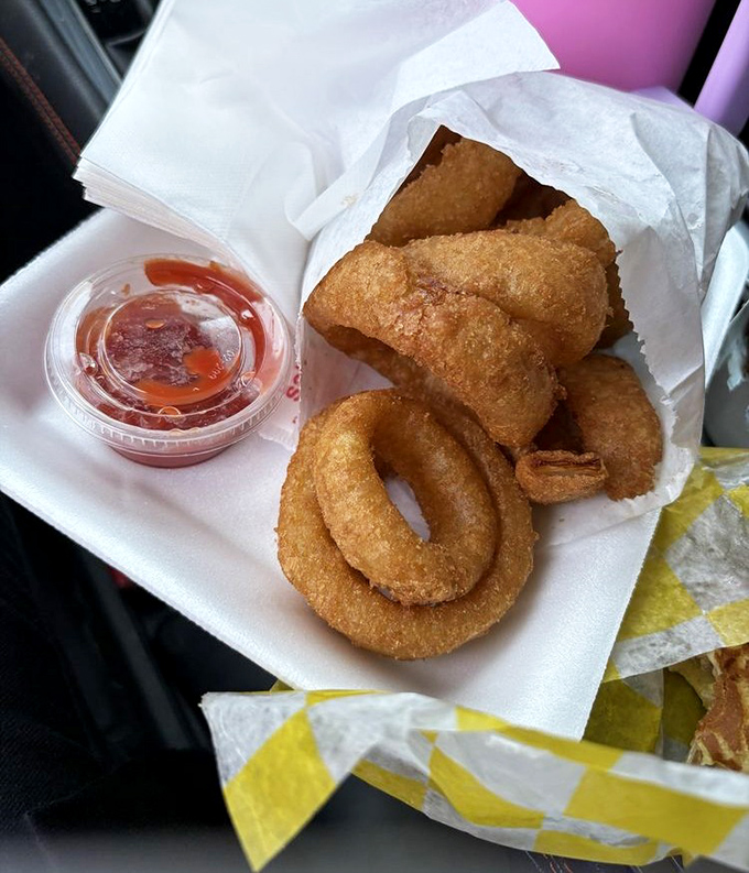 Golden-fried onion rings that shatter with each bite—the perfect marriage of sweet onion and crispy coating that puts fast food chains to shame.