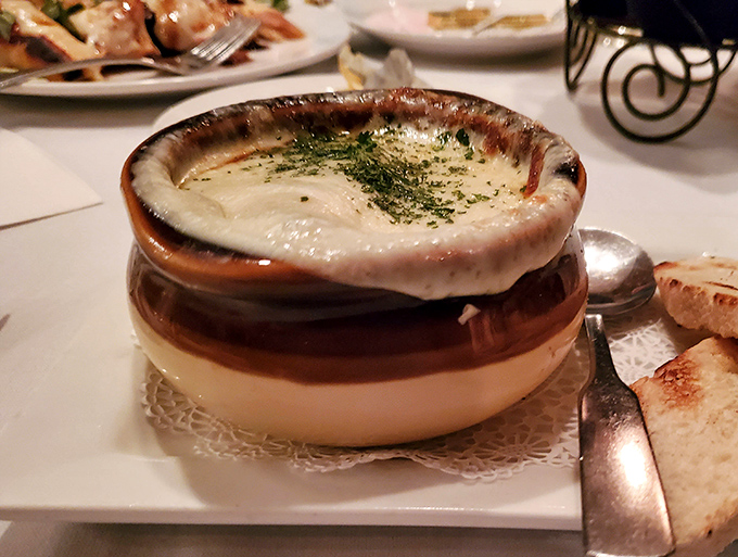 French onion soup wearing its cheese blanket like a cozy winter sweater you never want to take off.